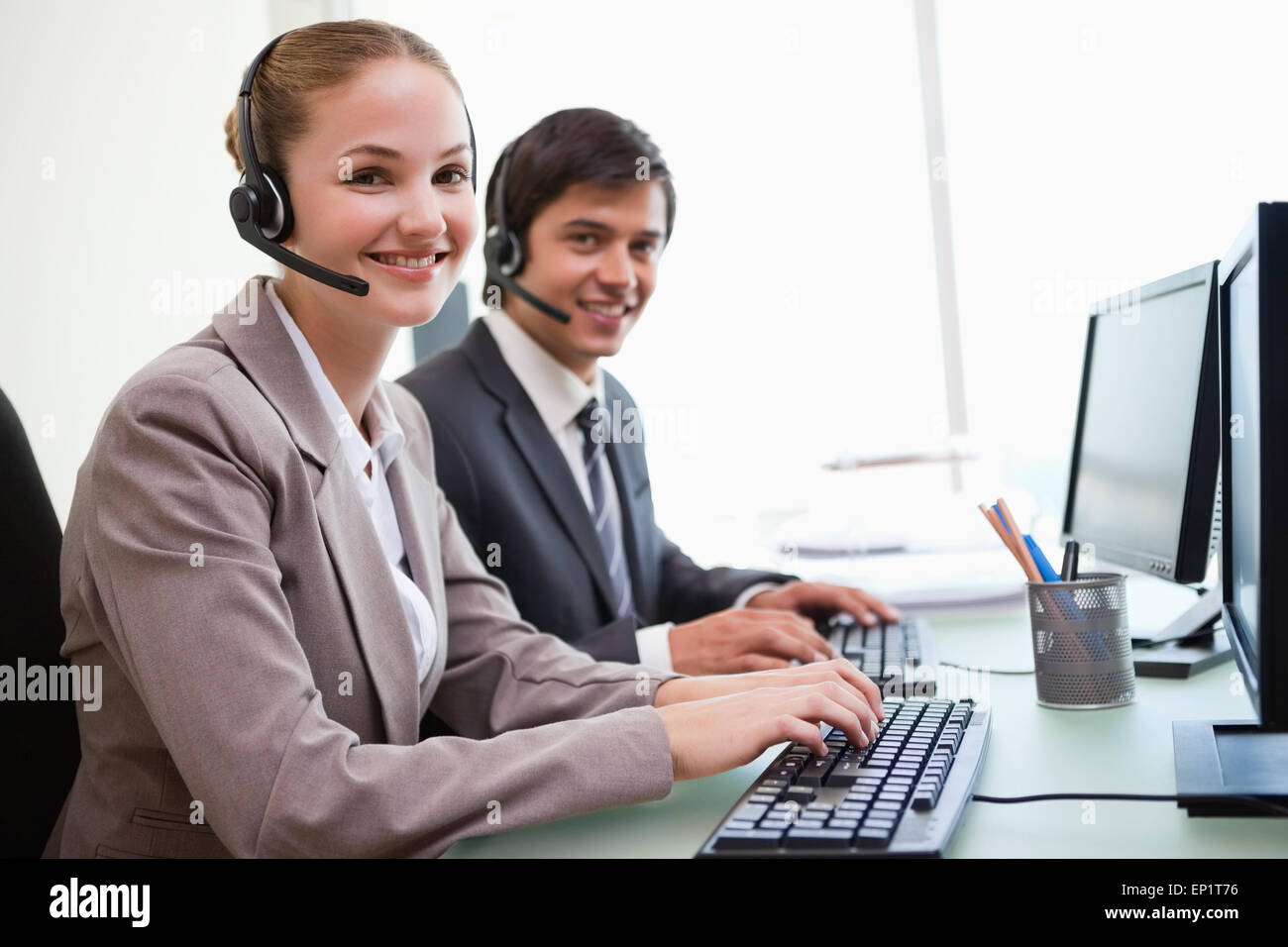 Young office workers using computers Stock Photo - Alamy