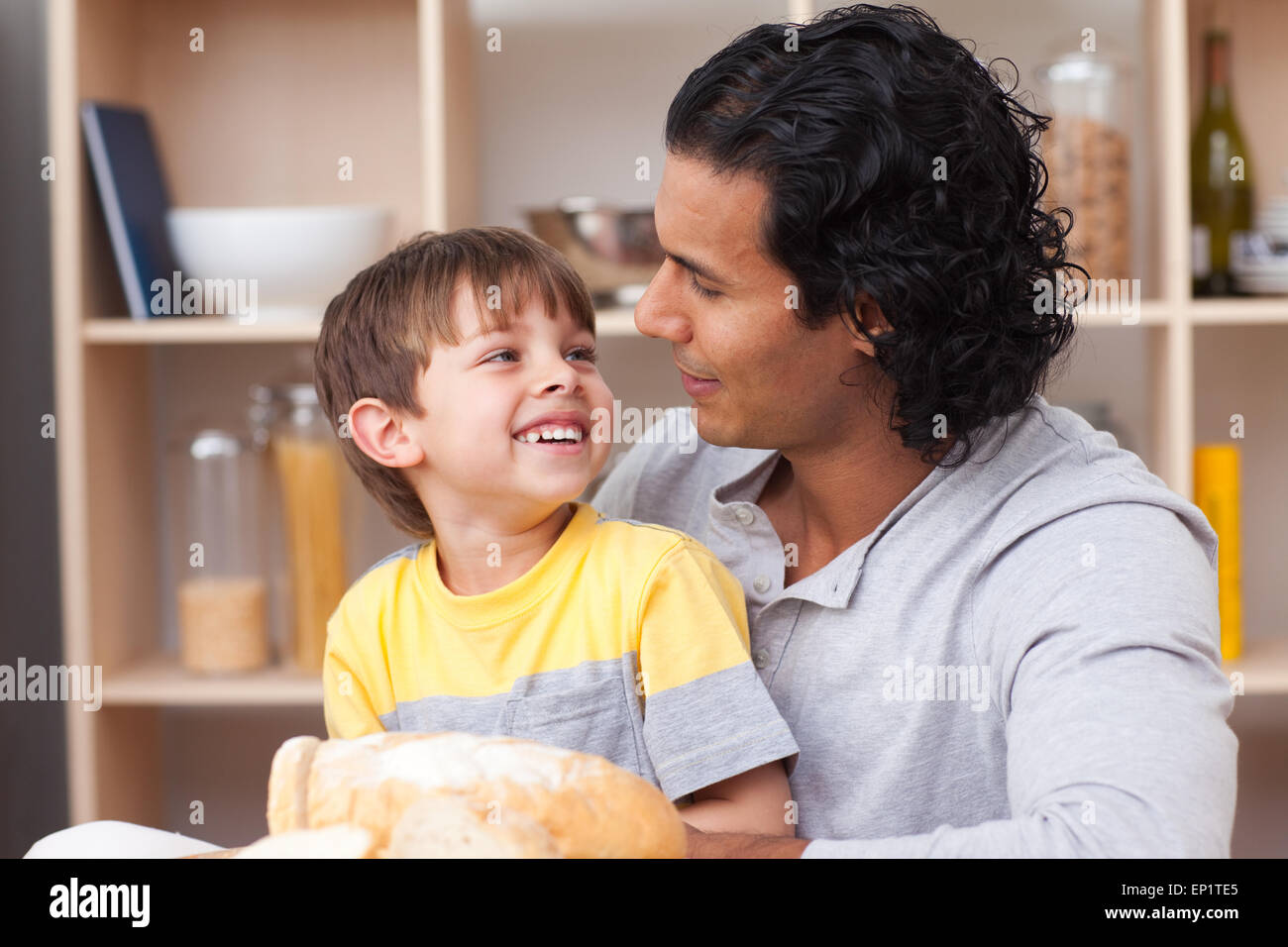 Cheerful child eating bread with his father Stock Photo - Alamy