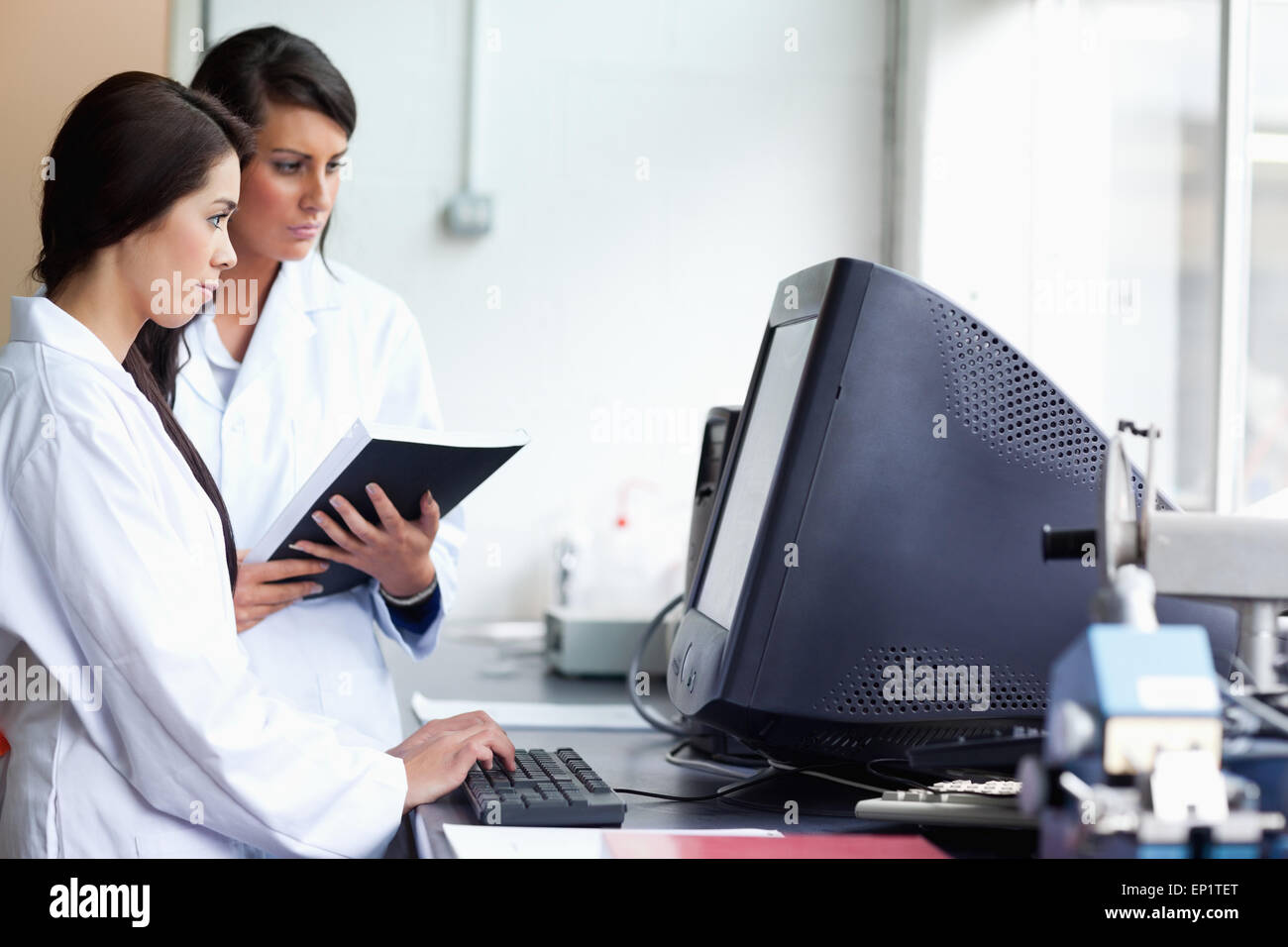 Female scientists using a monitor Stock Photo - Alamy