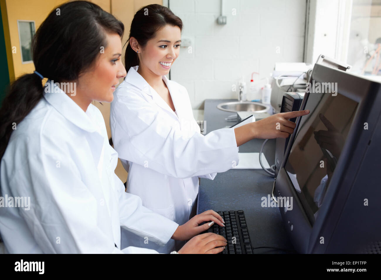 Cute scientists working with a monitor Stock Photo - Alamy Cute scientists working with a monitor Stock Photo - Alamy