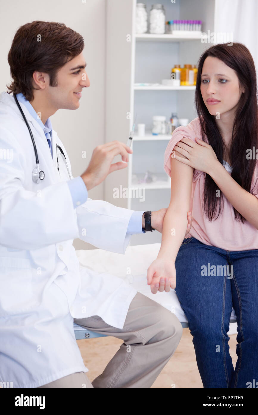 Male doctor about to give an injection to patient Stock Photo - Alamy