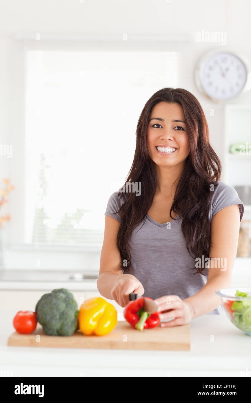 Pretty woman cooking vegetables while standing Stock Photo - Alamy