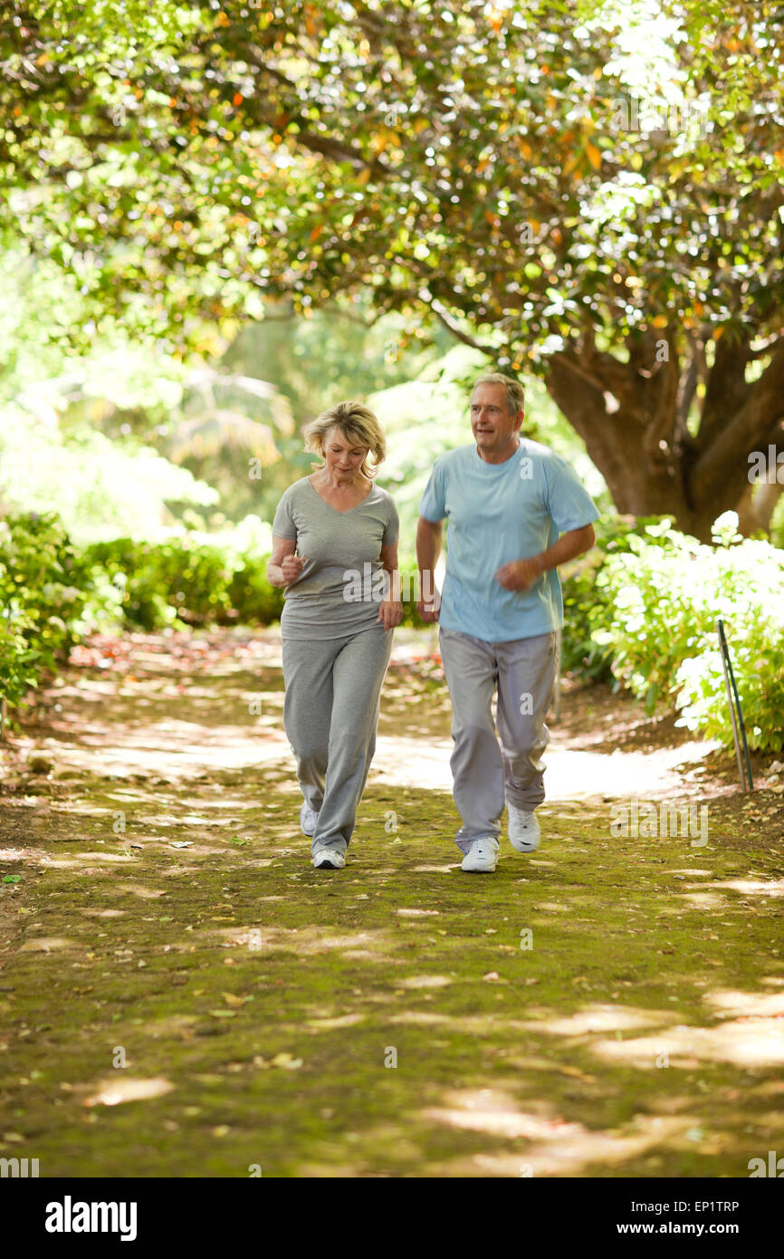 Couple running in the wood Stock Photo - Alamy