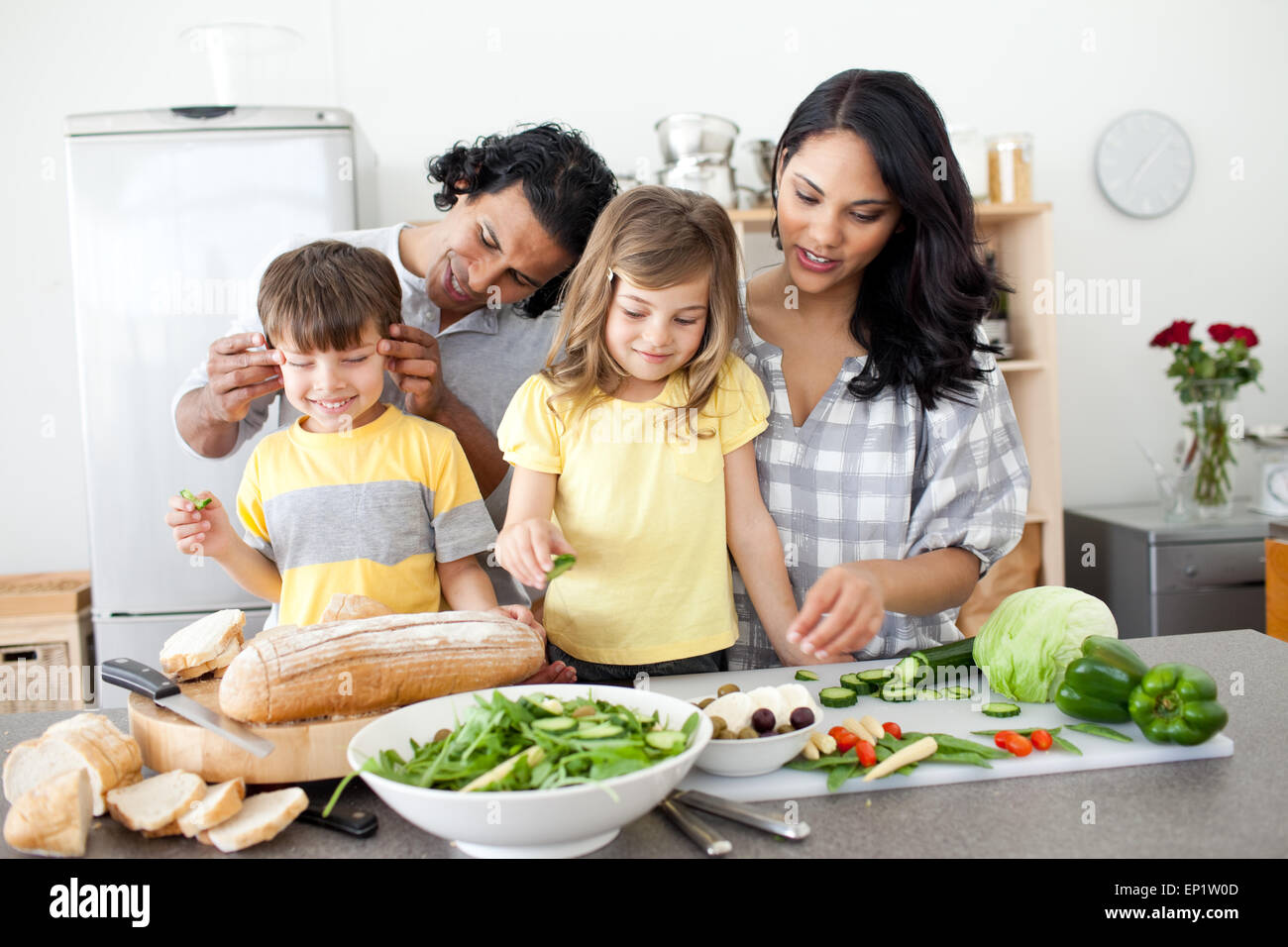 Jolly family preparing lunch together Stock Photo - Alamy