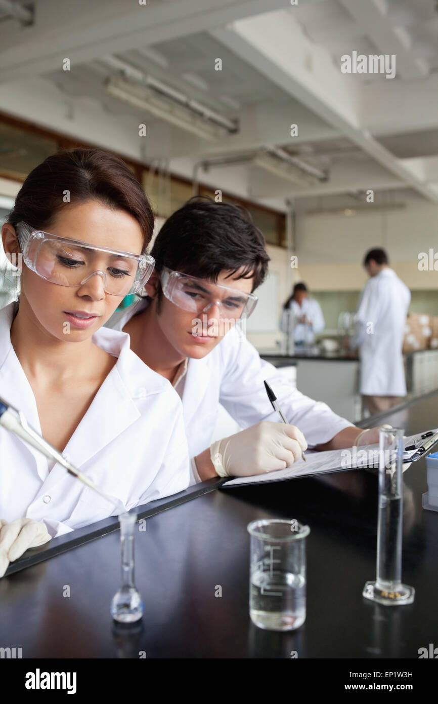 Portrait of young science students working Stock Photo - Alamy