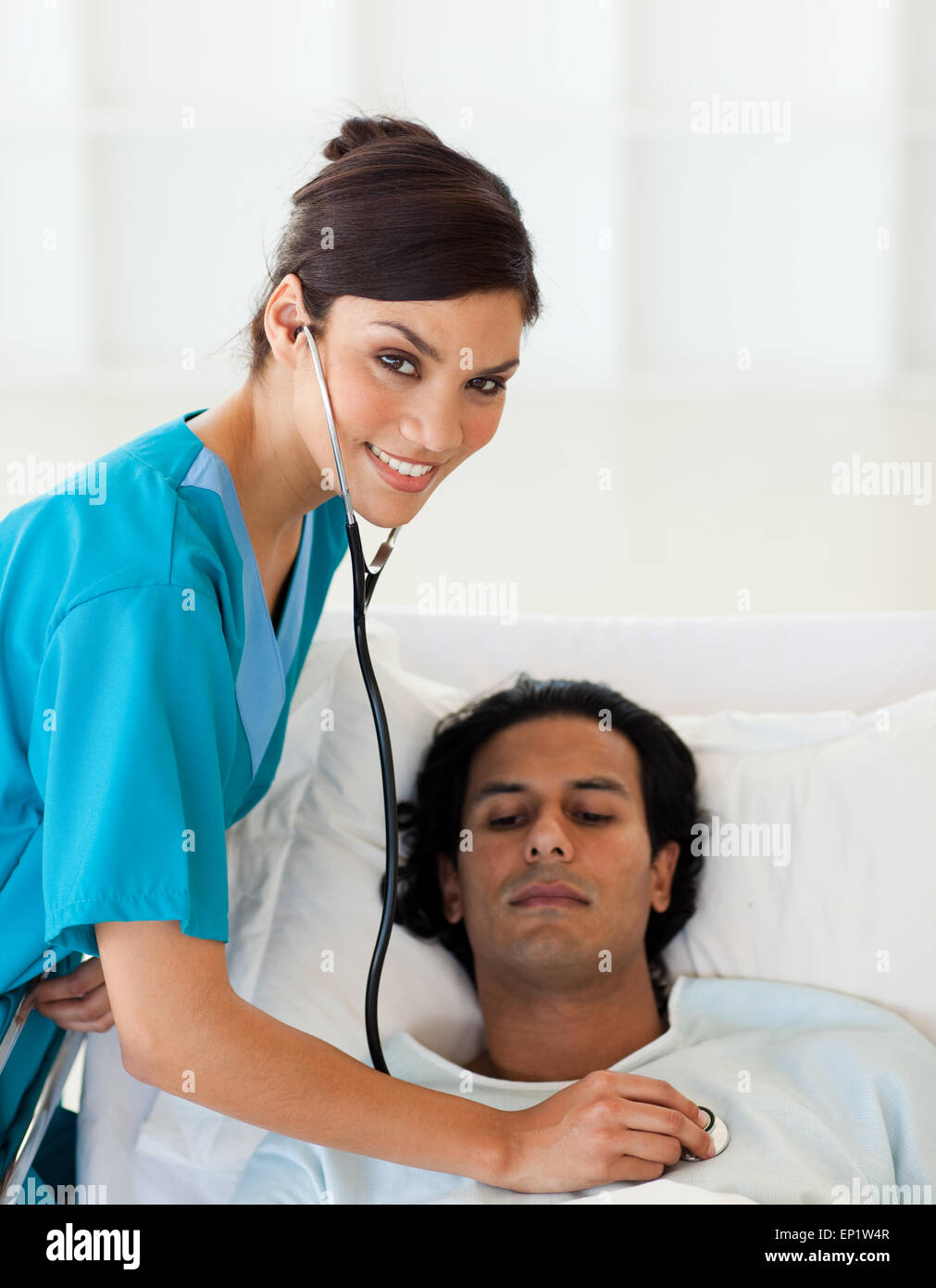 Female doctor checking the pulse of a patient Stock Photo - Alamy