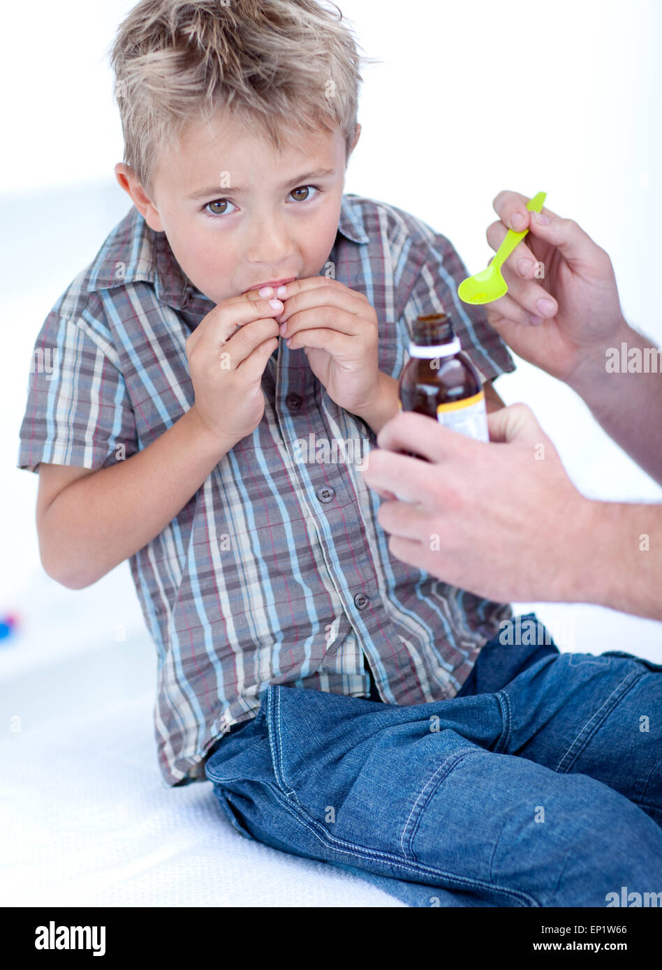 Cold child taking syrup Stock Photo - Alamy