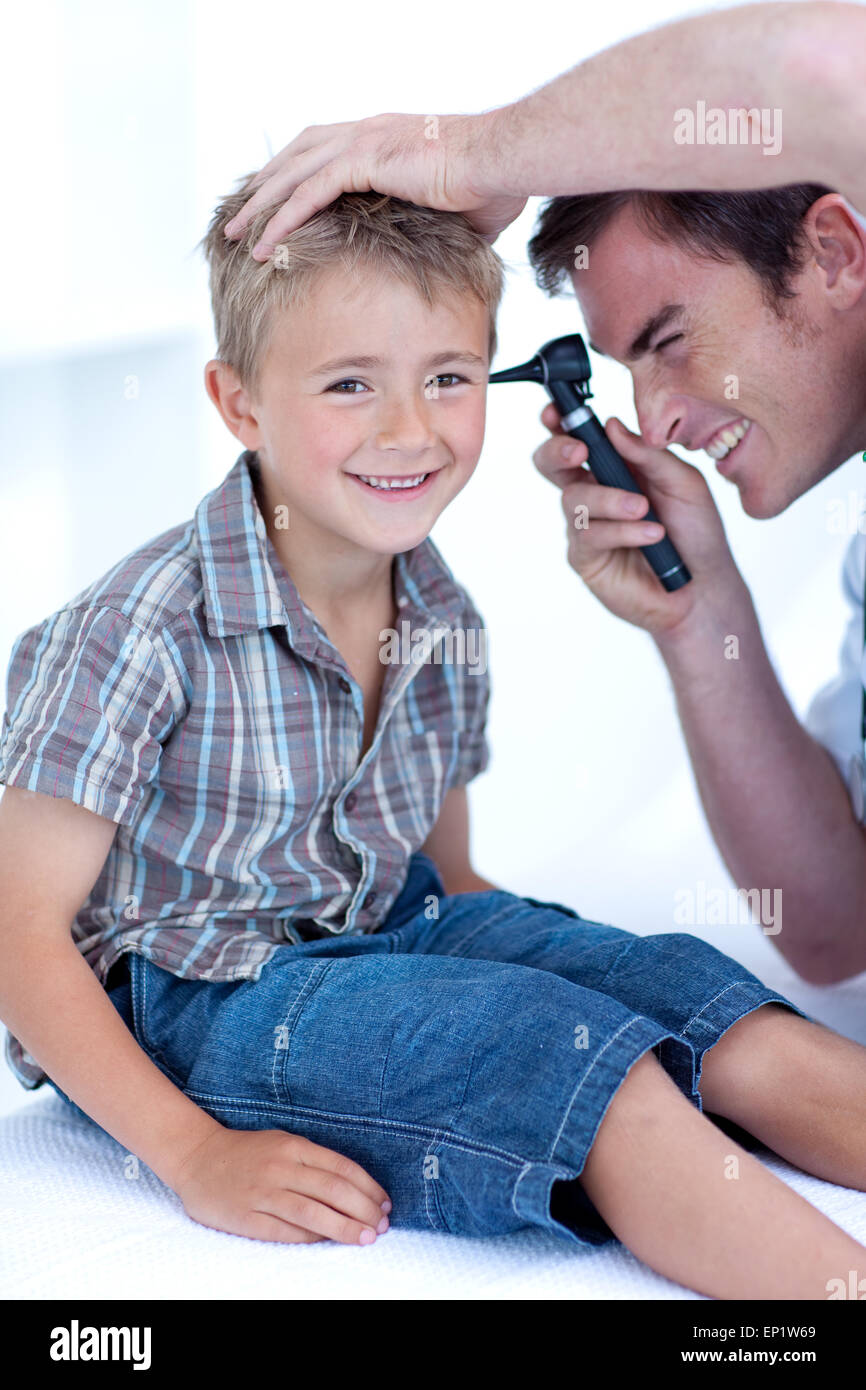 Doctor checking a patient' s ears Stock Photo - Alamy