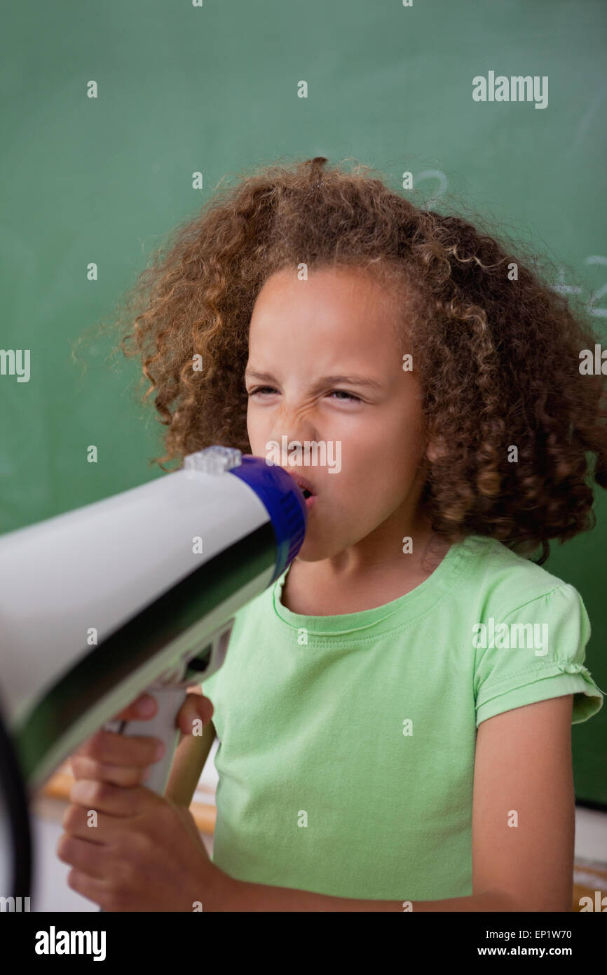Portrait of a schoolgirl screaming through a megaphone Stock Photo - Alamy