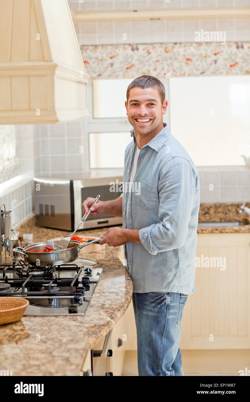 Handsome man cooking in the kitchen Stock Photo - Alamy