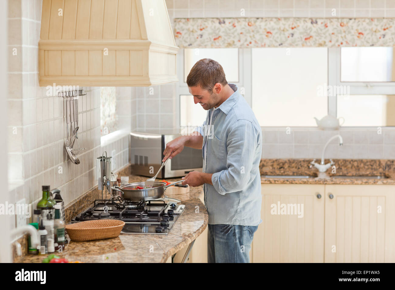 Handsome man cooking in the kitchen Stock Photo - Alamy