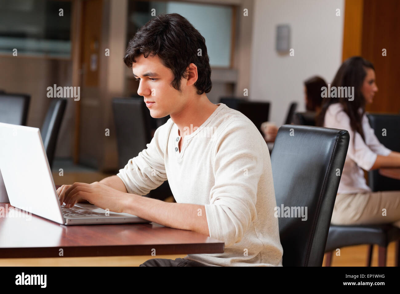 Handsome man using a notebook Stock Photo - Alamy
