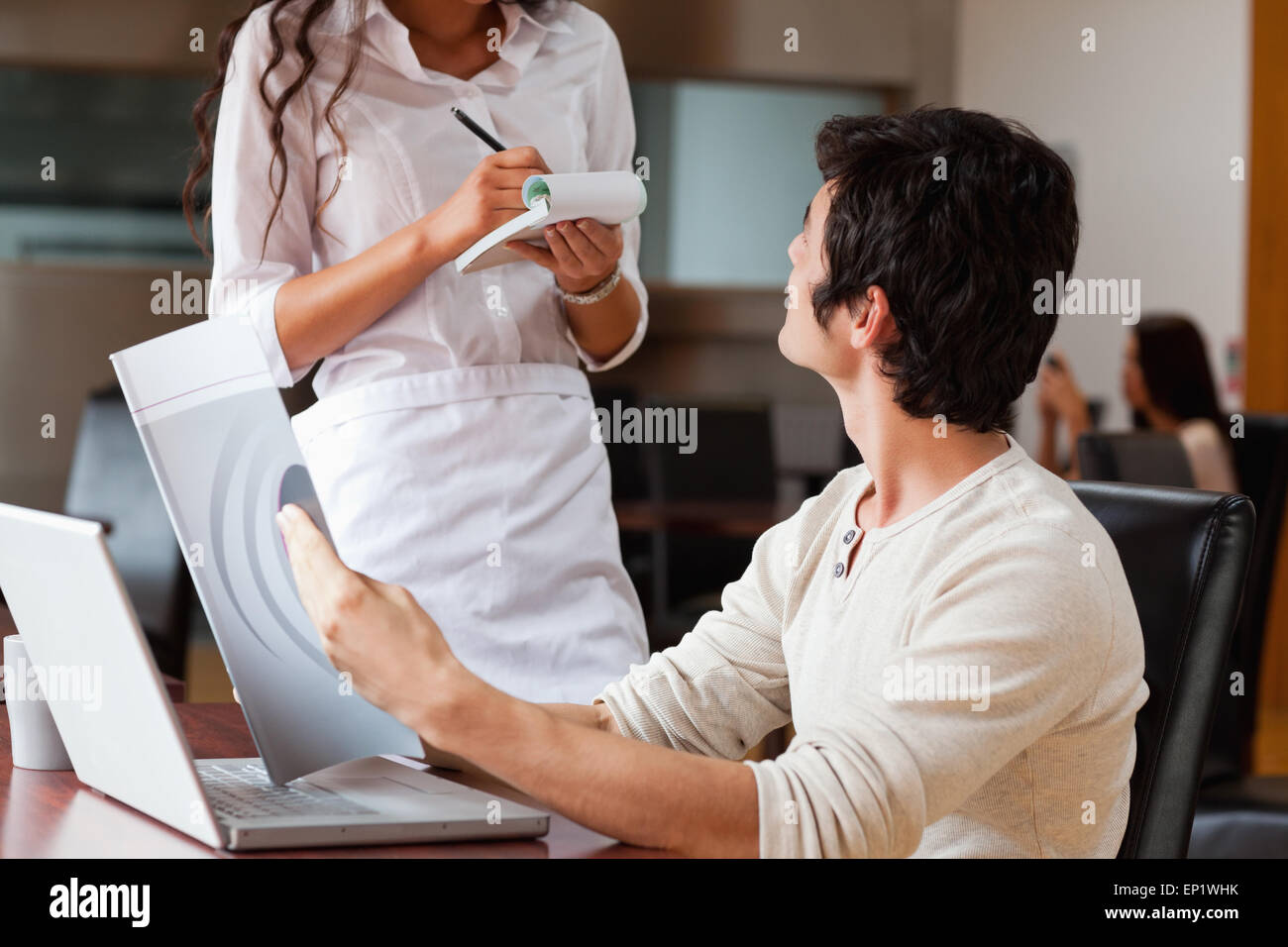 Young man ordering food to a waitress Stock Photo - Alamy