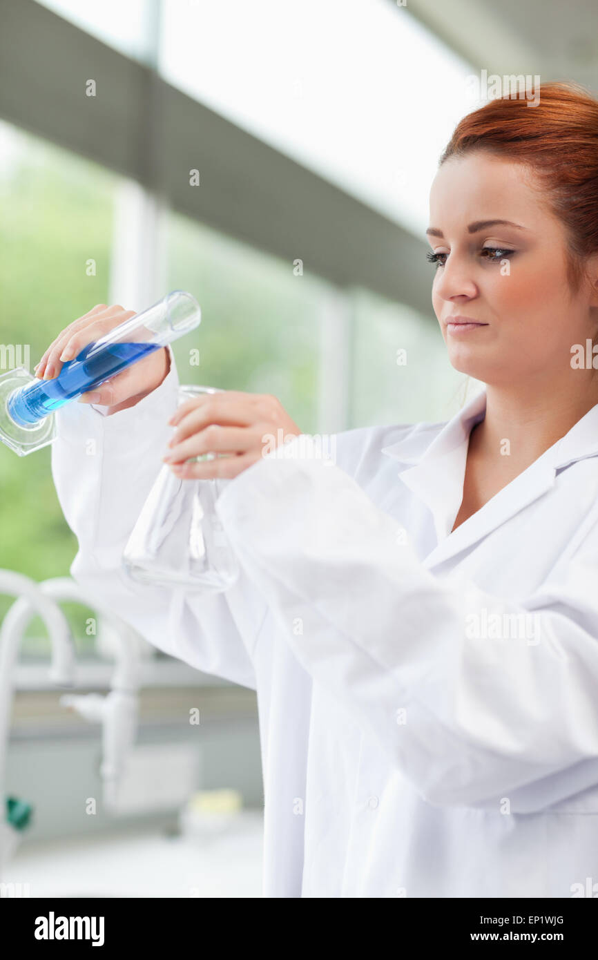 Portrait of a science student pouring liquid in an Erlenmeyer fl Stock ...