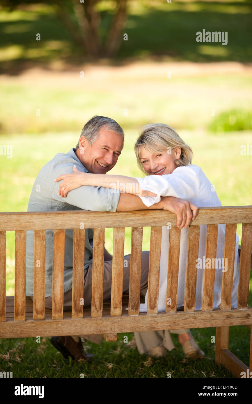 Happy retired couple sitting on the bench Stock Photo - Alamy