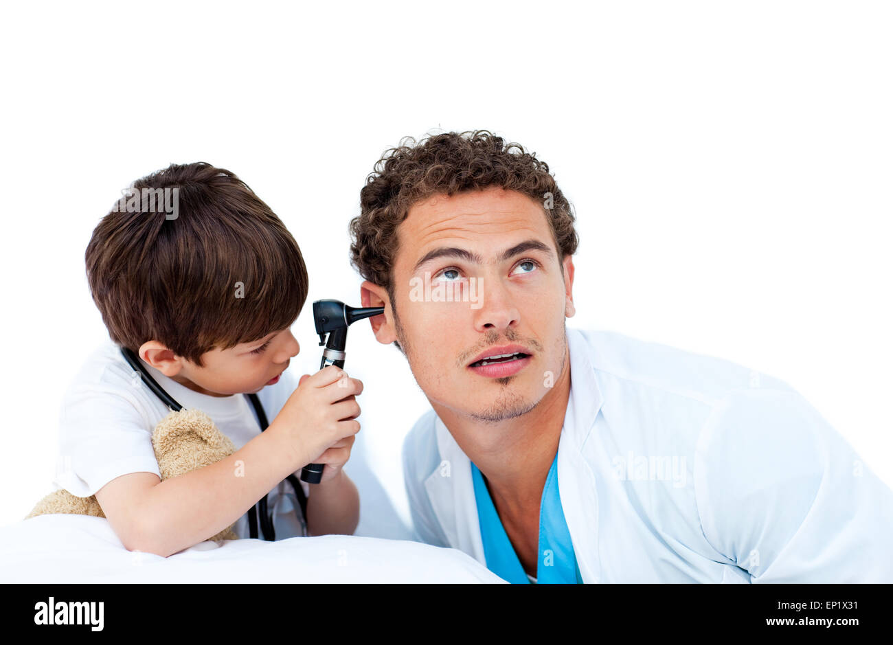 Cute little boy checking doctor's ears against a white background Stock ...