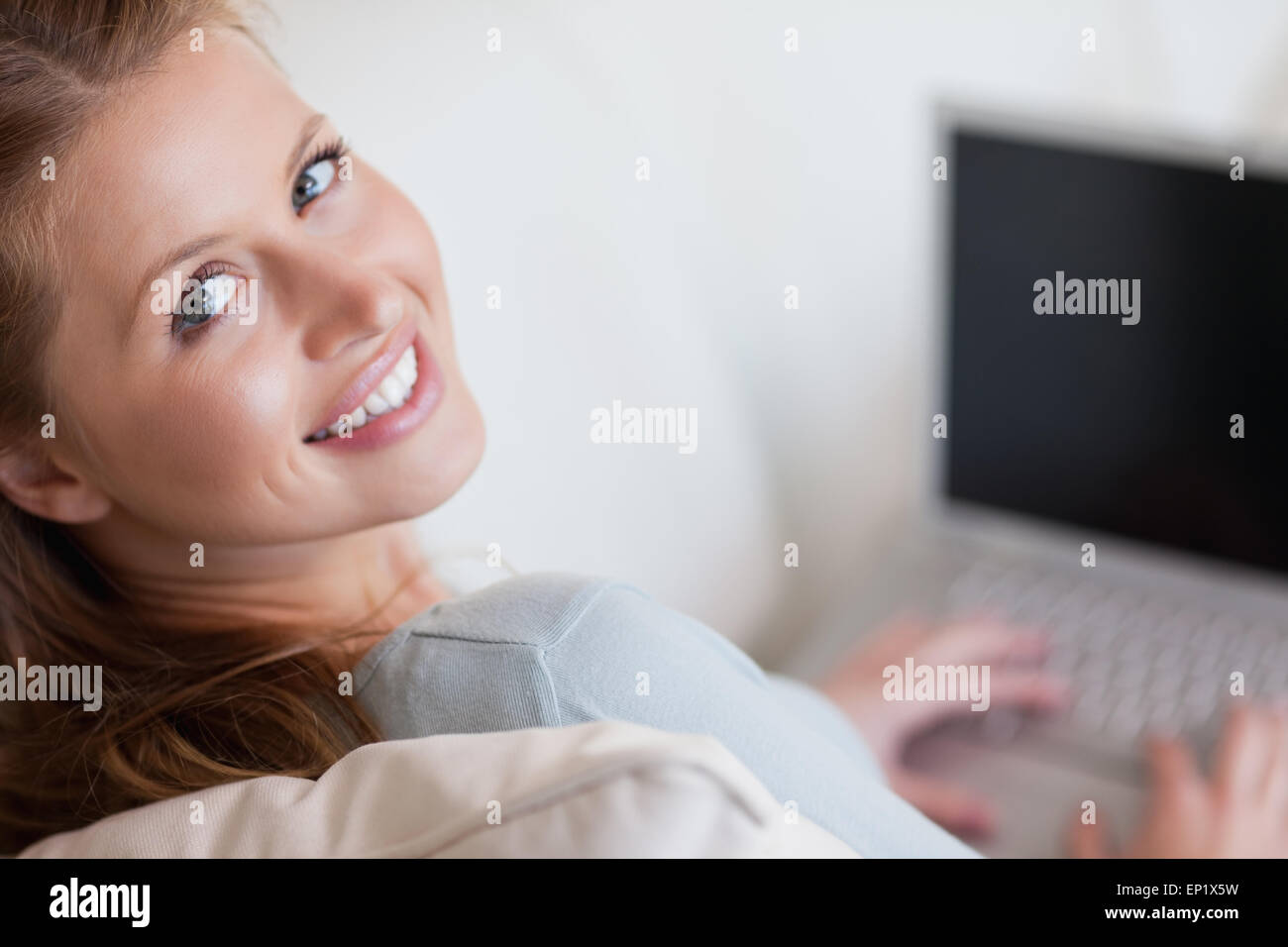 Shadowing woman with laptop on the sofa Stock Photo - Alamy