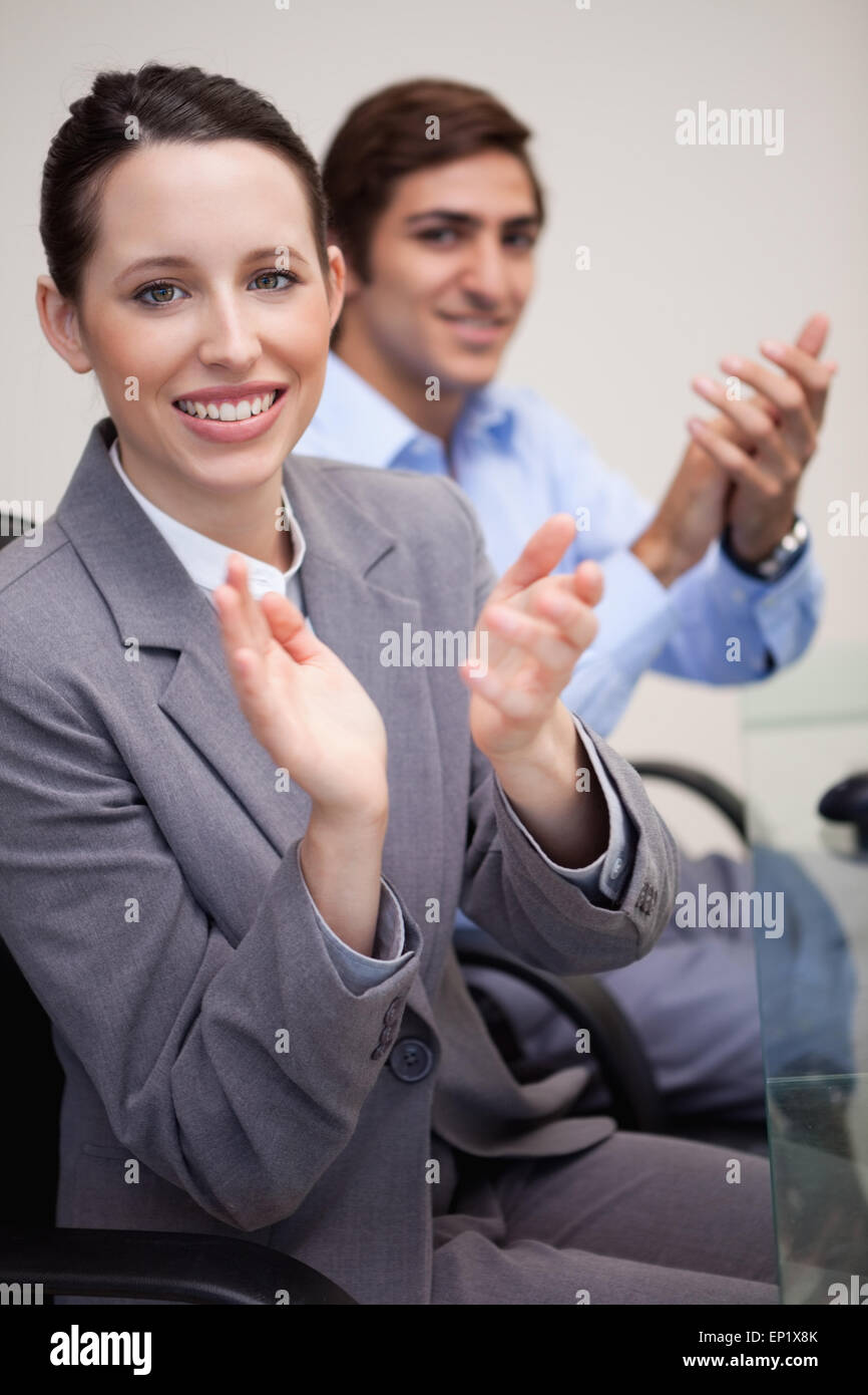 Side view of clapping business team sitting at desk Stock Photo - Alamy