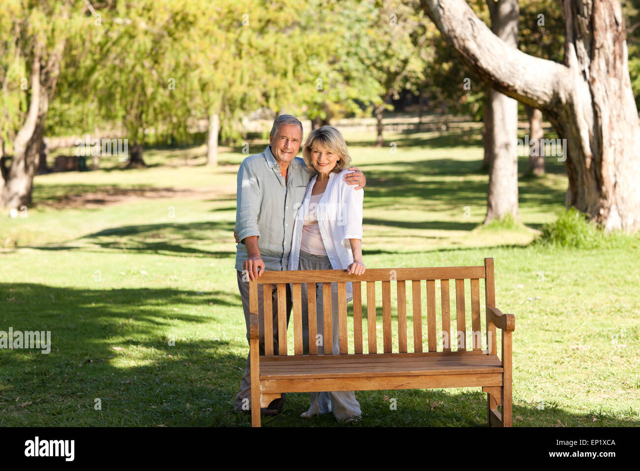 Portrait of a lovely couple behind the bench Stock Photo - Alamy