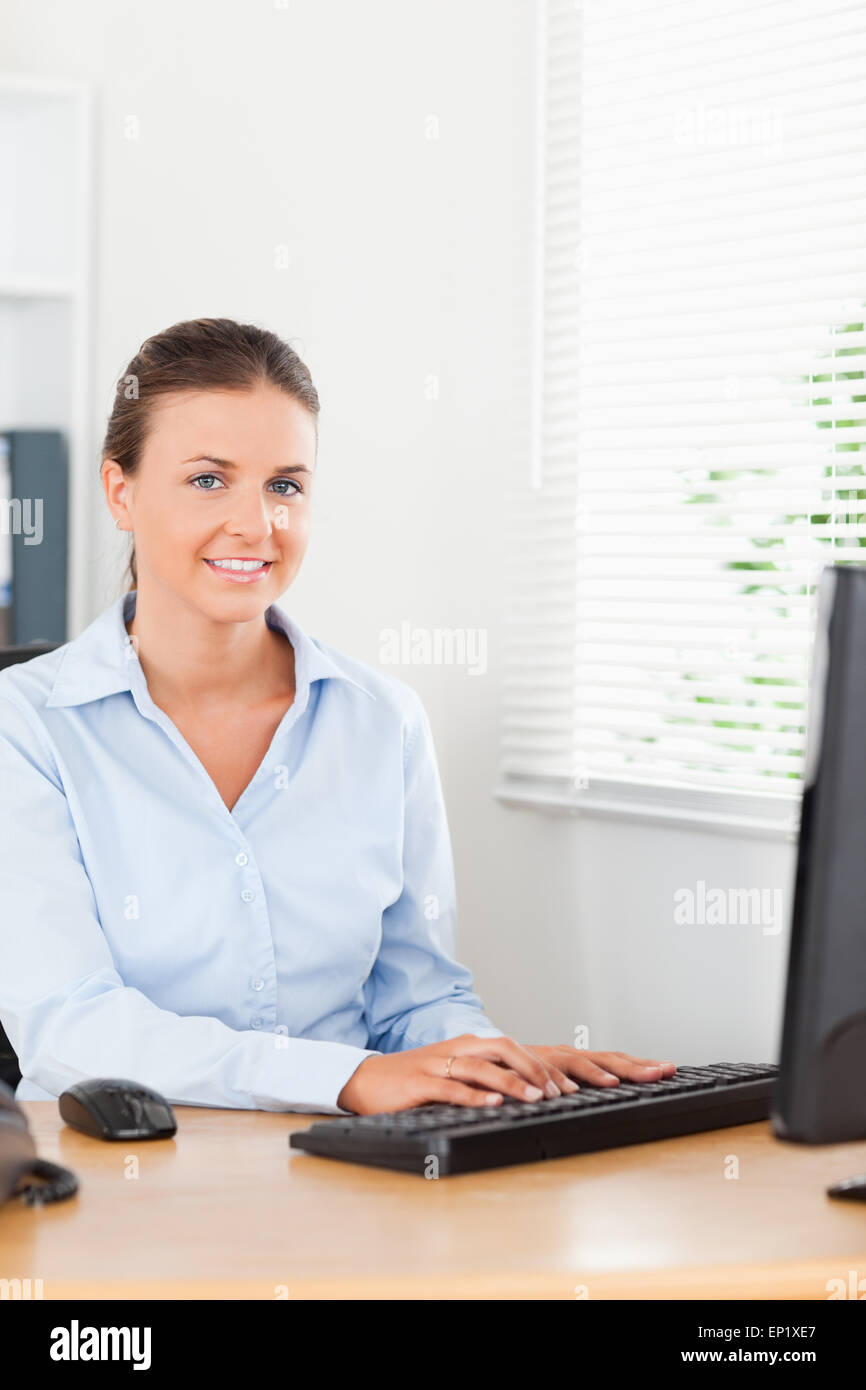 Smiling secretary in office Stock Photo - Alamy