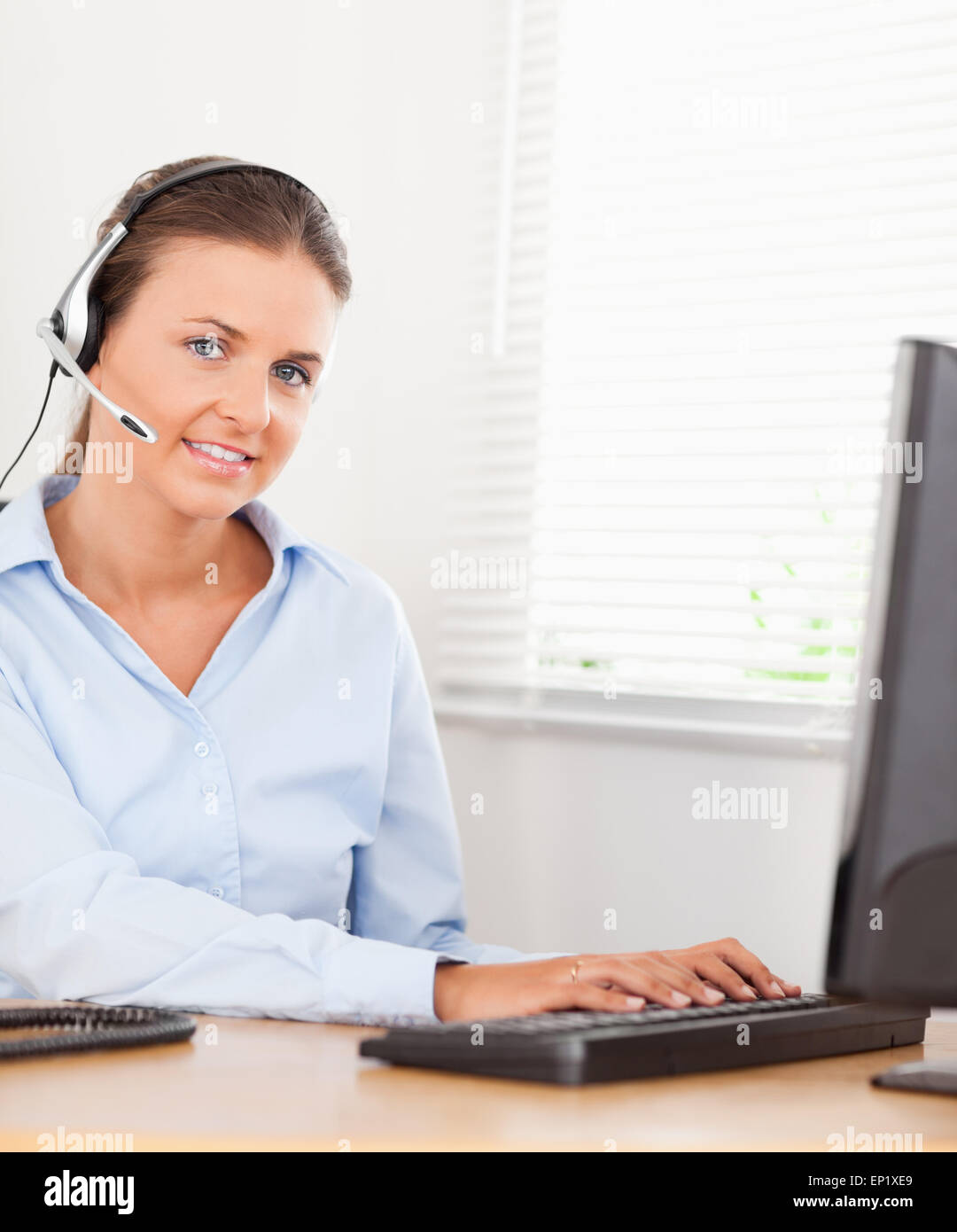 An operator with headset in an office Stock Photo - Alamy