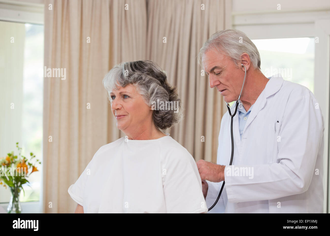 Doctor examining his patient Stock Photo - Alamy