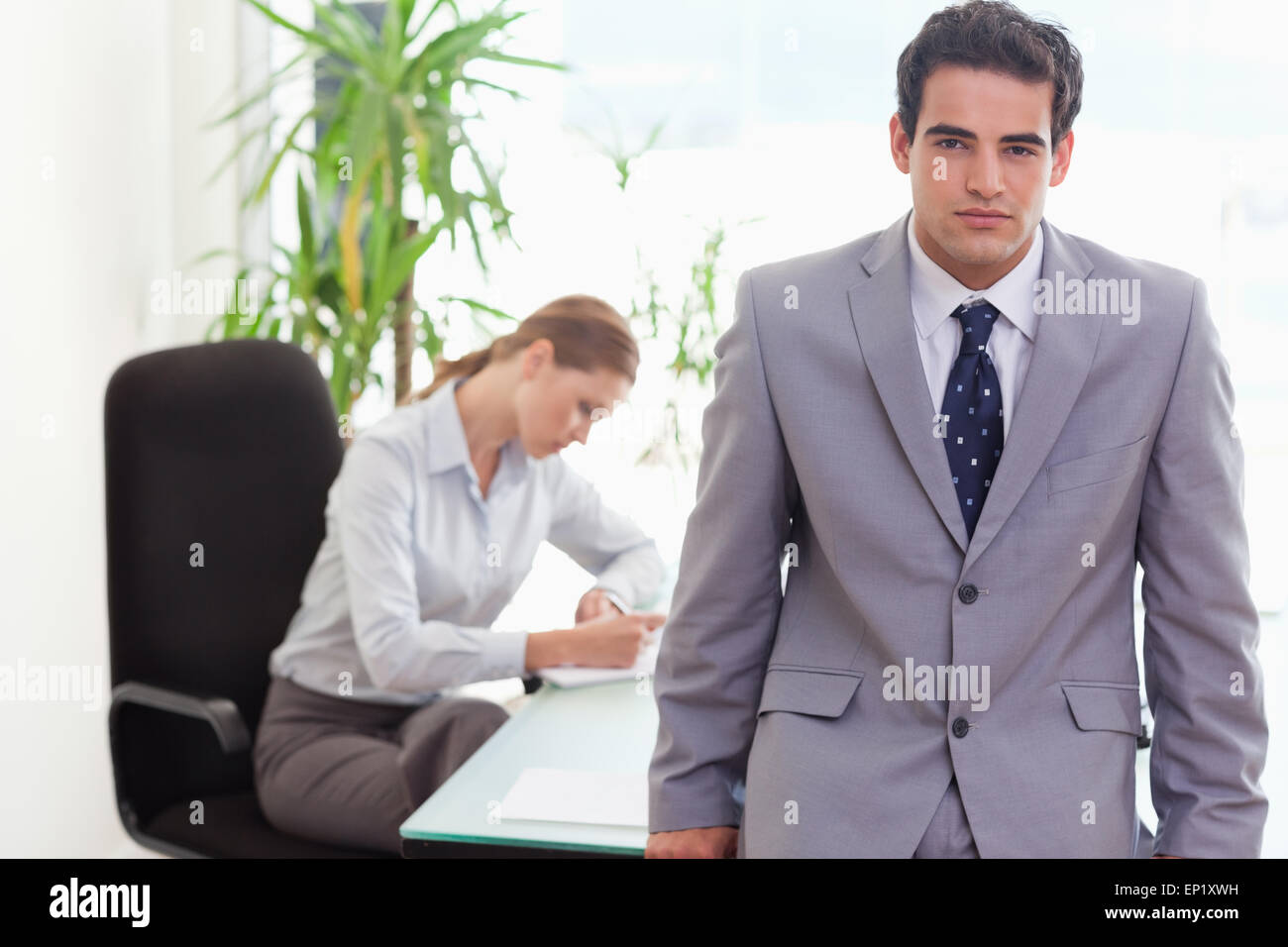 Serious looking tradesman with colleague behind him Stock Photo - Alamy