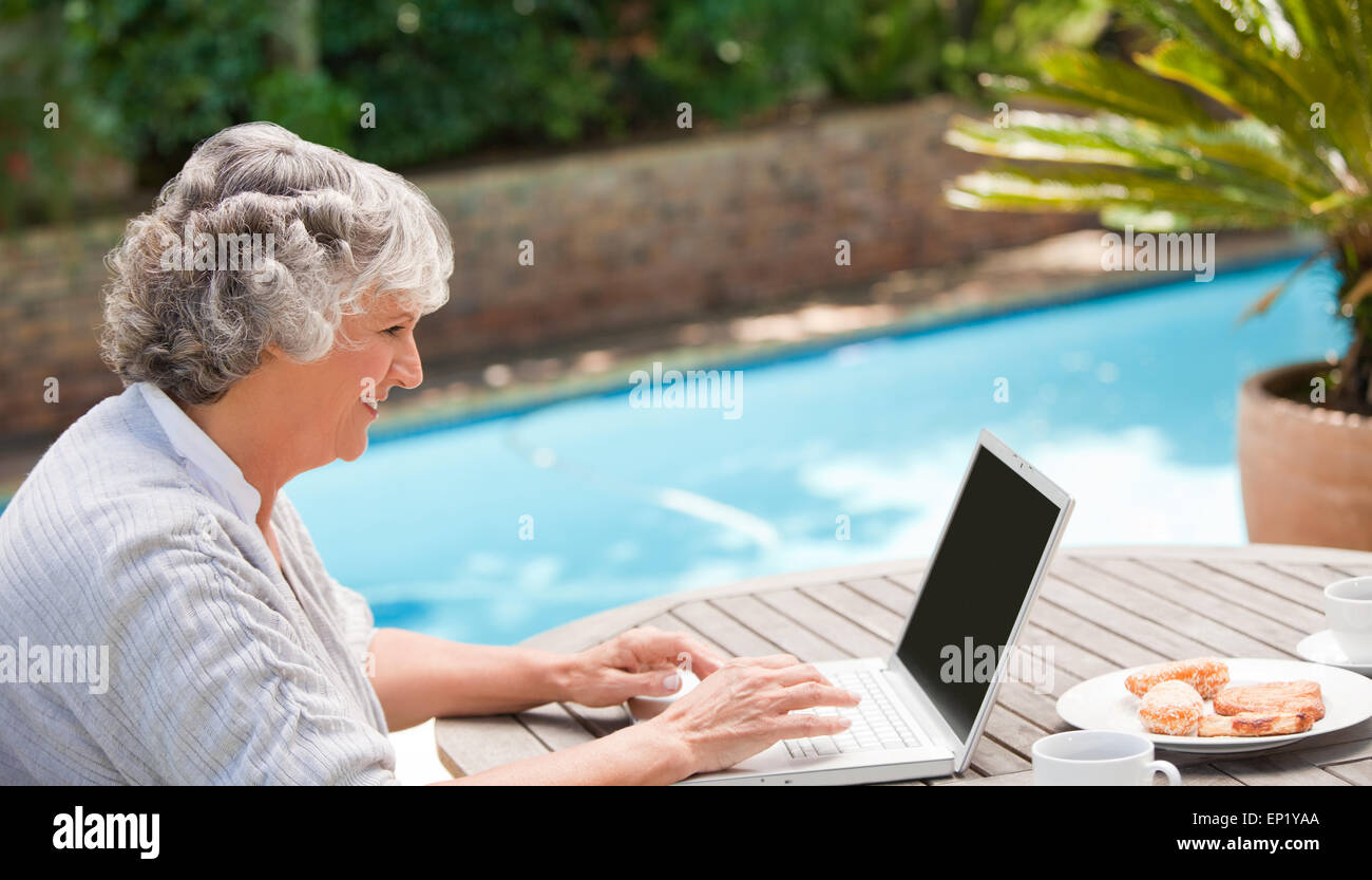 Mature woman working on her laptop Stock Photo - Alamy