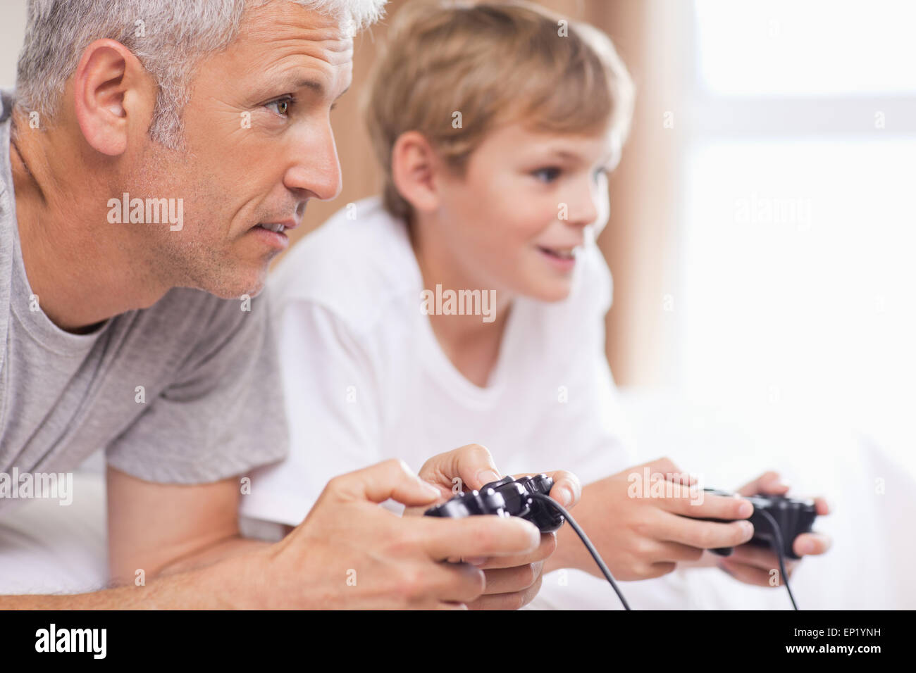 Father playing video games with his young son Stock Photo - Alamy