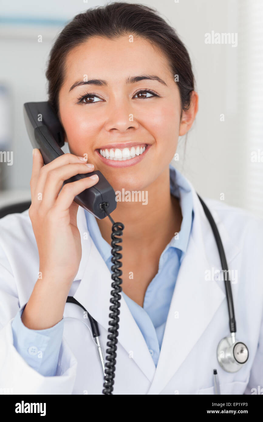 Beautiful female doctor on the phone and posing Stock Photo - Alamy