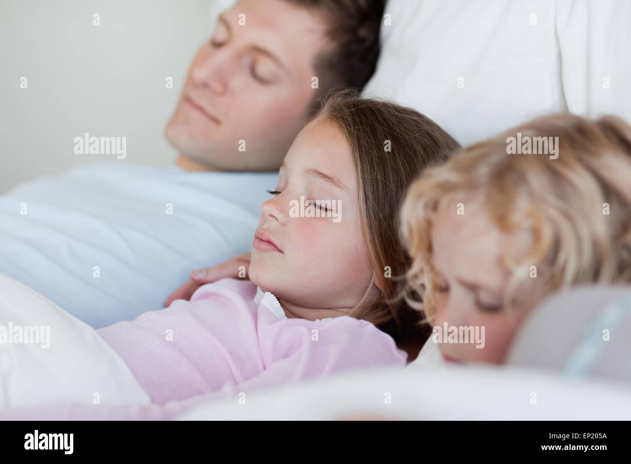 Father taking a nap with his children Stock Photo - Alamy