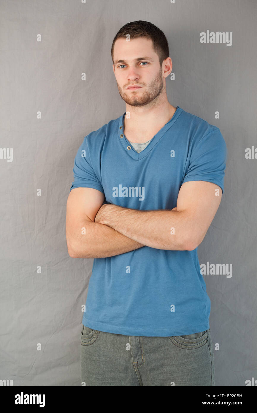 Serious looking male with arms folded Stock Photo - Alamy