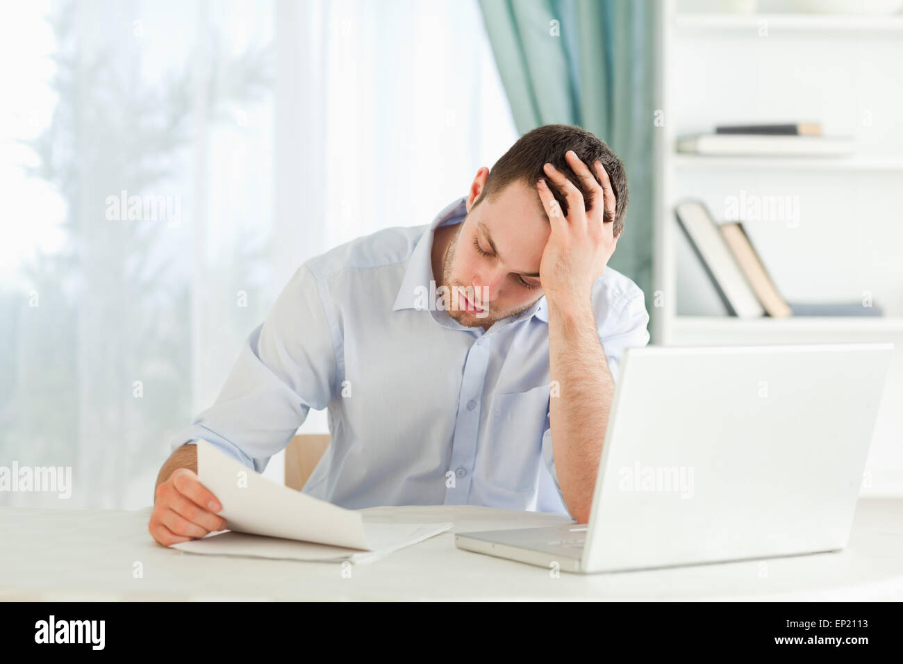 Businessman reading an alarming letter Stock Photo - Alamy