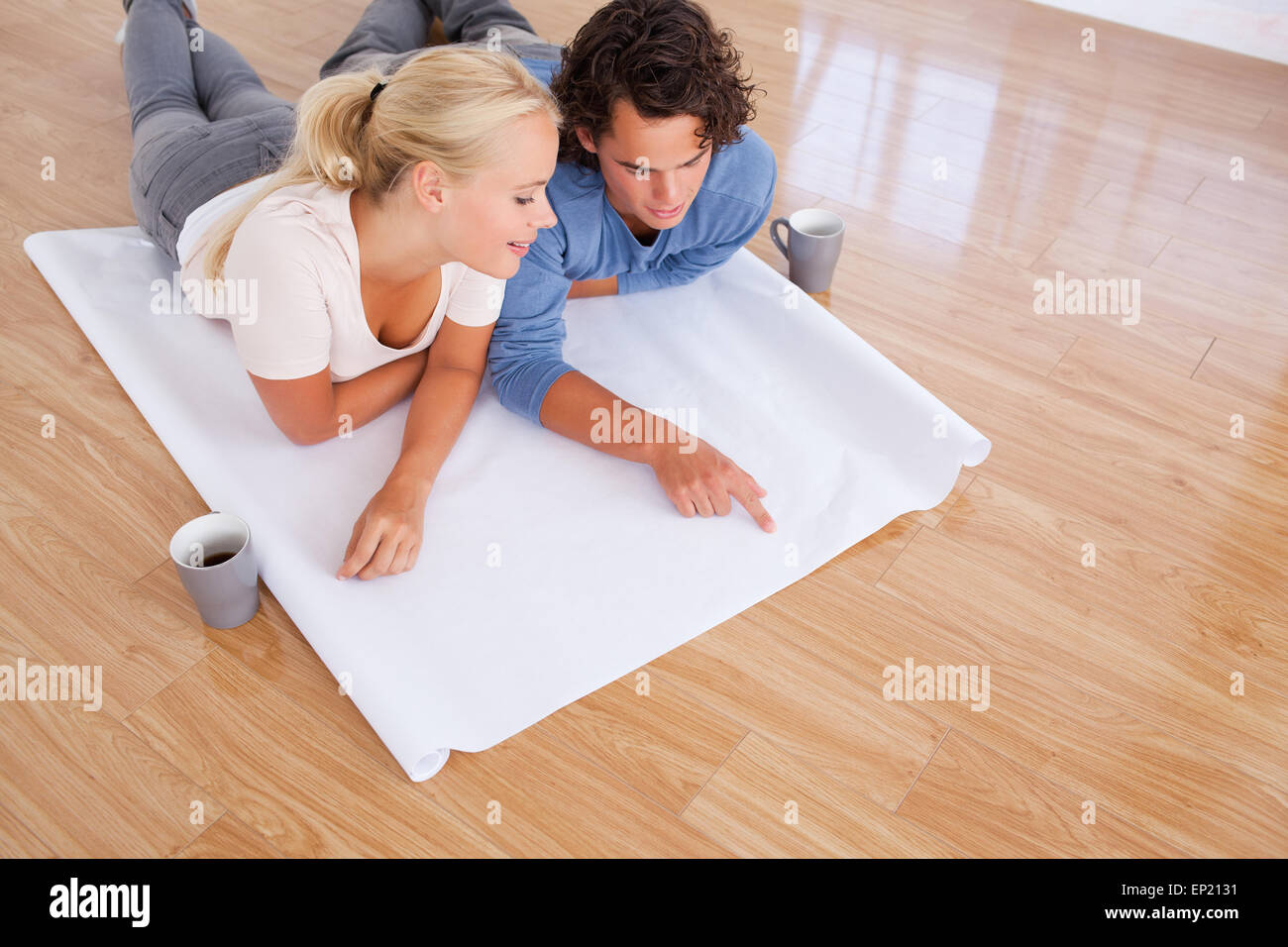 Cute man showing a point on a plan to his fiance Stock Photo - Alamy