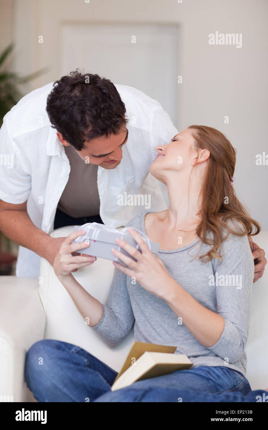 Man giving his girlfriend a present Stock Photo - Alamy