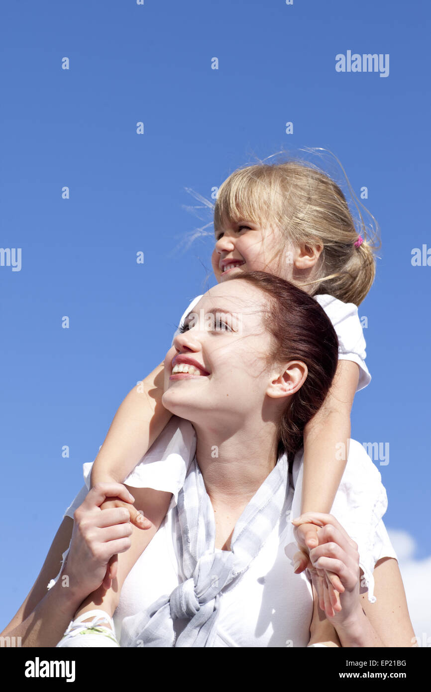 Mother giving her daughter piggyback ride Stock Photo - Alamy