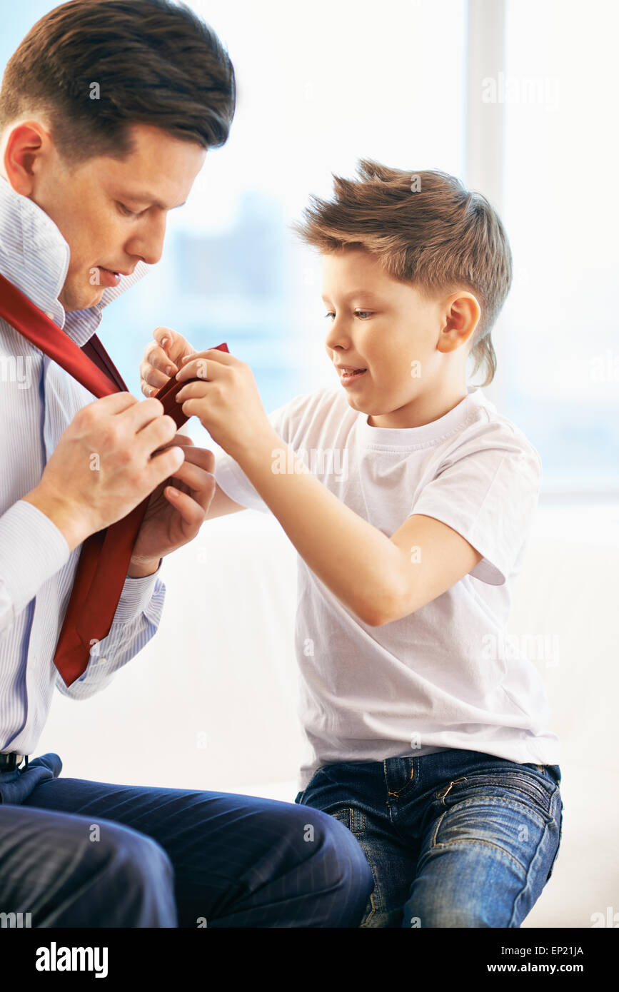 Father and son getting dressed Stock Photo - Alamy
