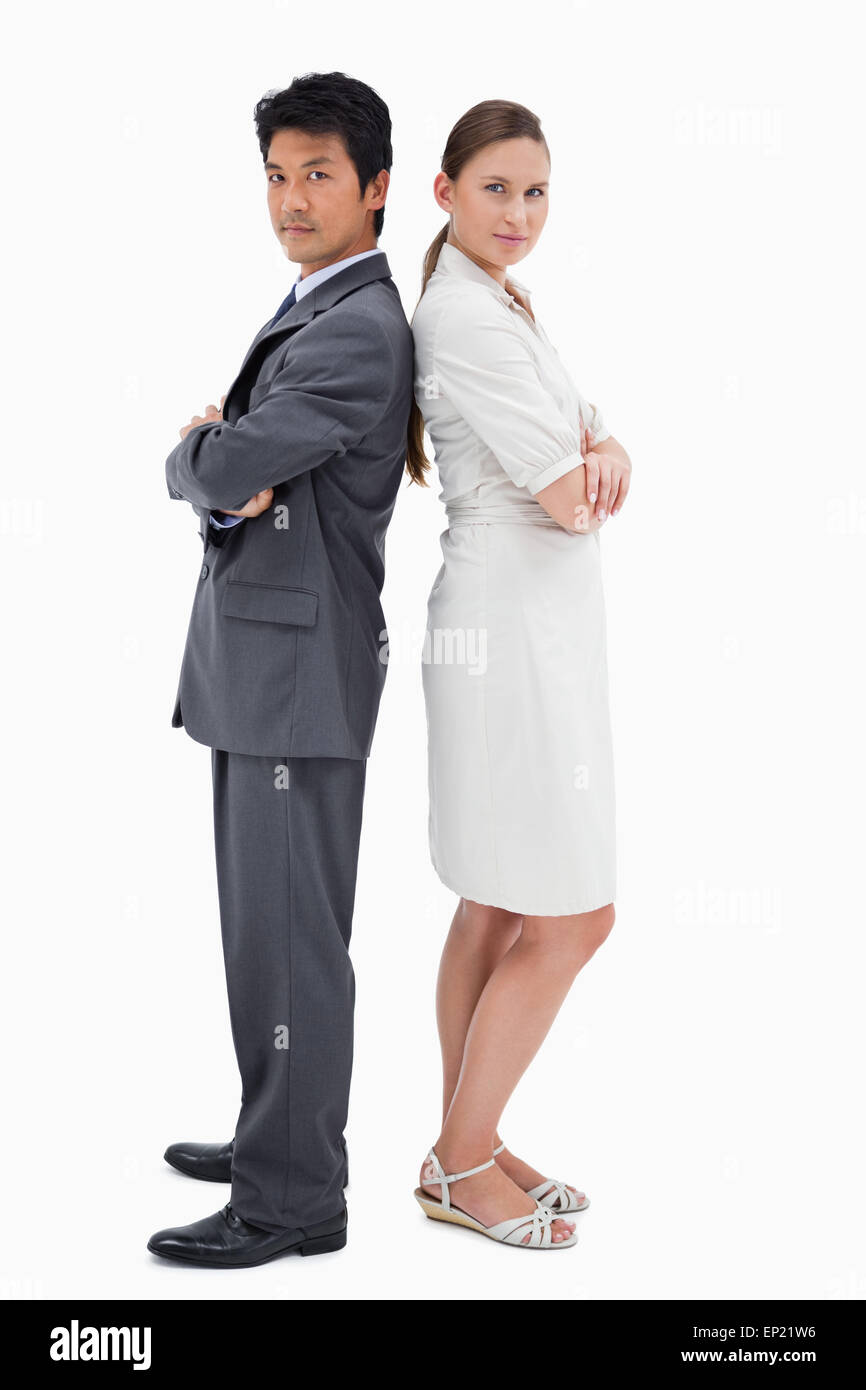 Portrait of business people standing back to back Stock Photo - Alamy