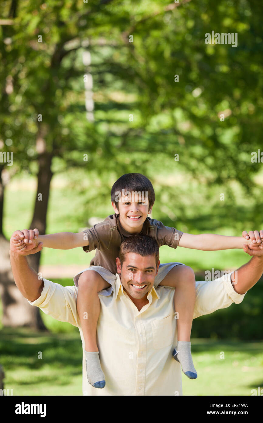 Handsome man giving son a piggyback Stock Photo - Alamy
