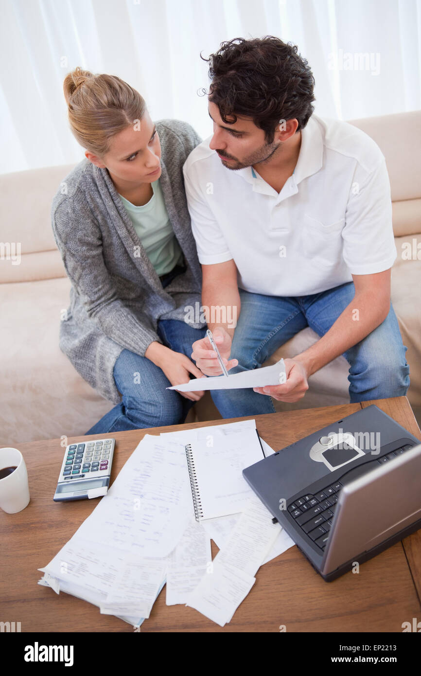 Portrait of a young couple doing their accounting with a notebook Stock ...