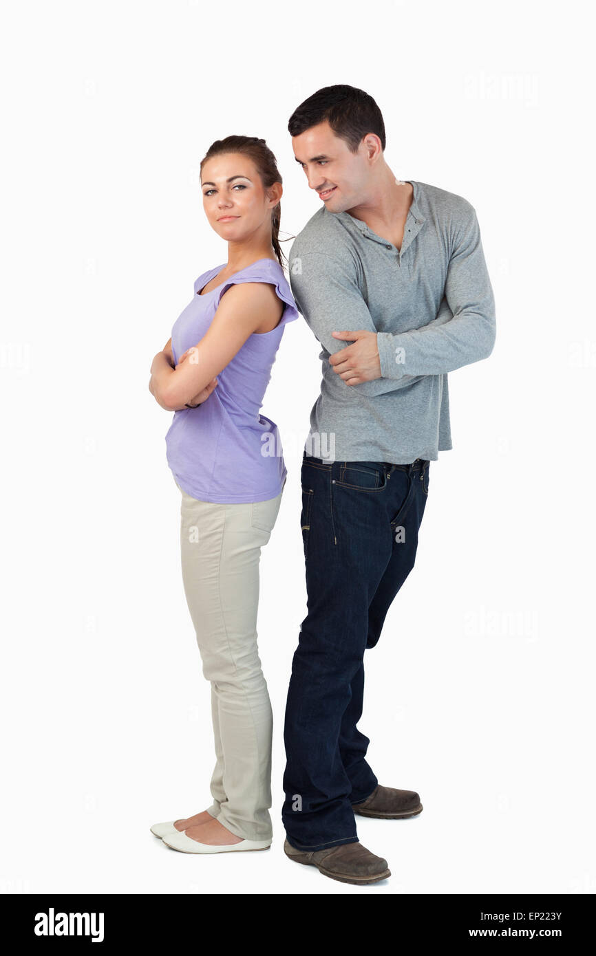 Young couple standing back-to-back to each other Stock Photo - Alamy