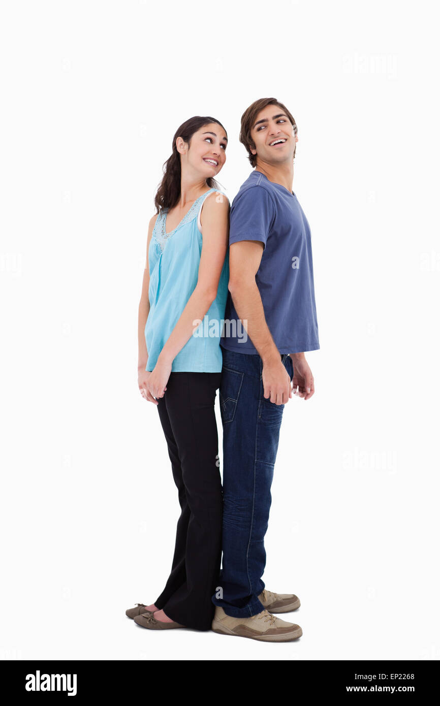 Portrait of a smiling couple standing back to back Stock Photo - Alamy