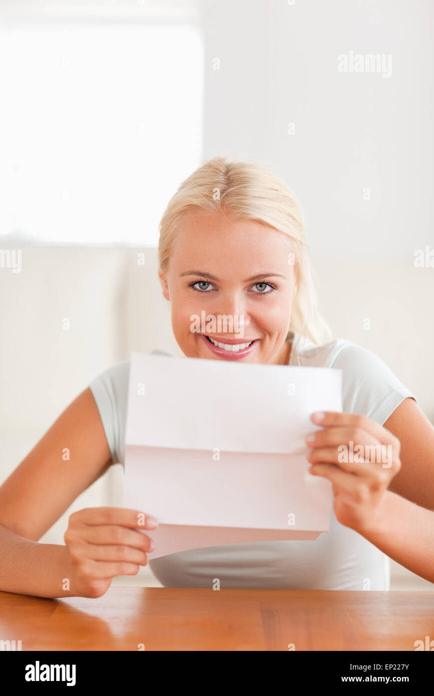 Grinning woman holding a letter Stock Photo - Alamy