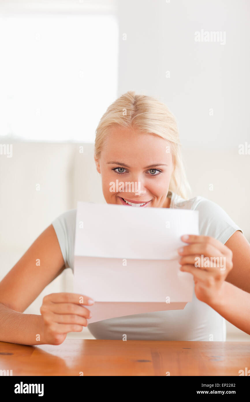 Smiling woman reading a letter Stock Photo - Alamy