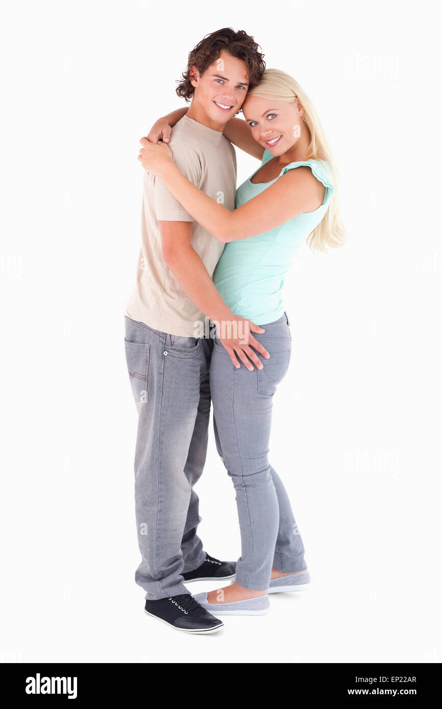 Hugging cute couple looking into the camera Stock Photo - Alamy