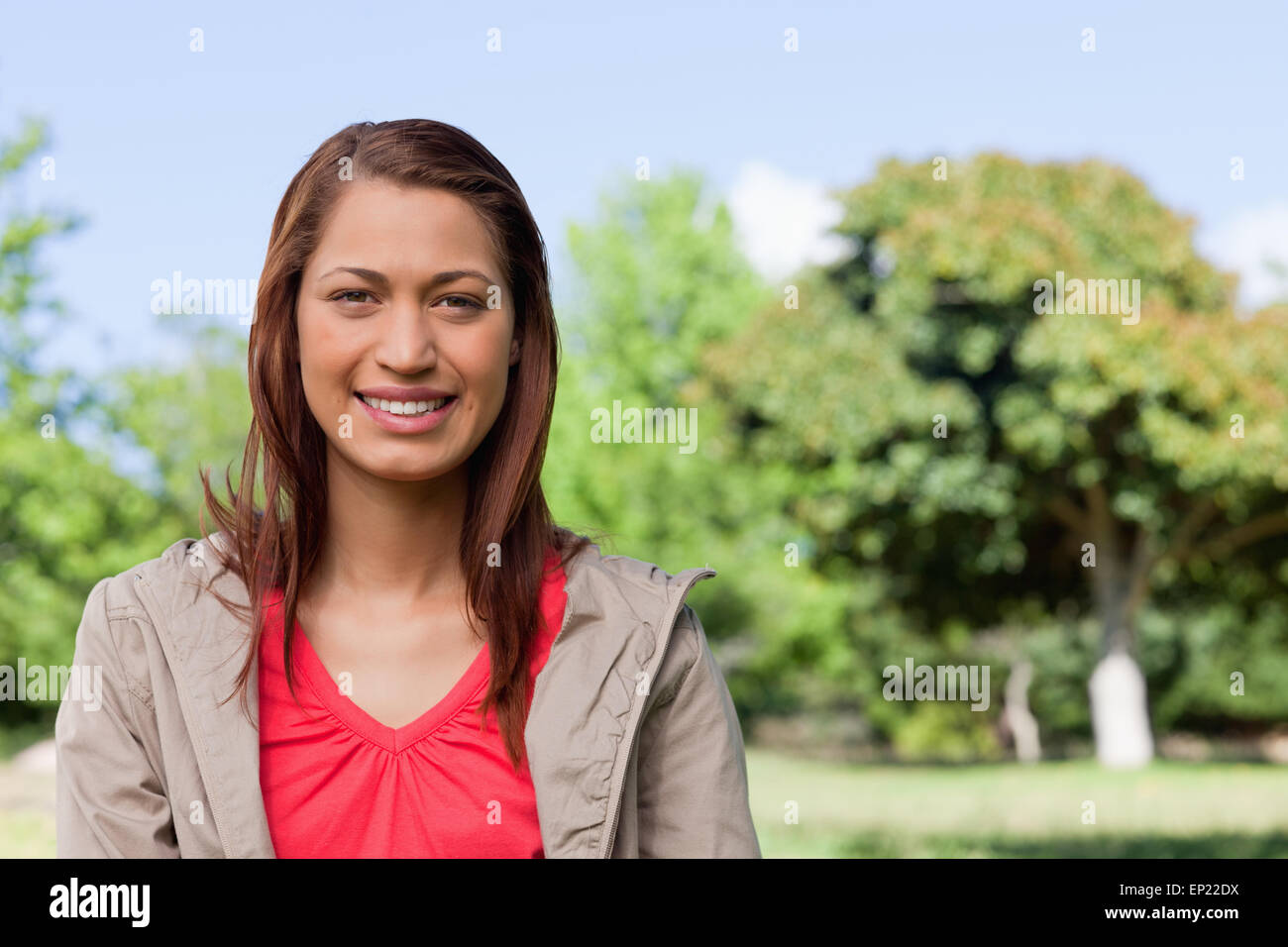 Young woman looking straight ahead with a smile on her face Stock Photo ...