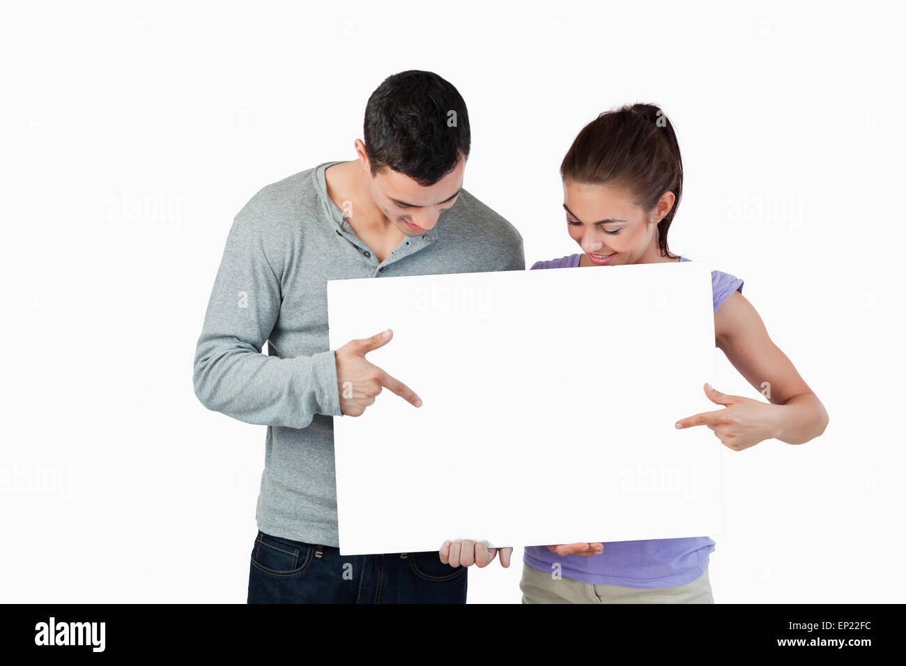 Young couple pointing at banner they are presenting Stock Photo - Alamy