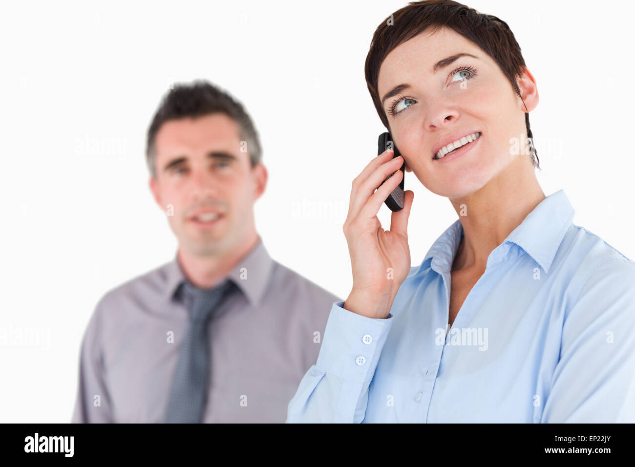 Woman making a phone call while her colleague is posing Stock Photo - Alamy