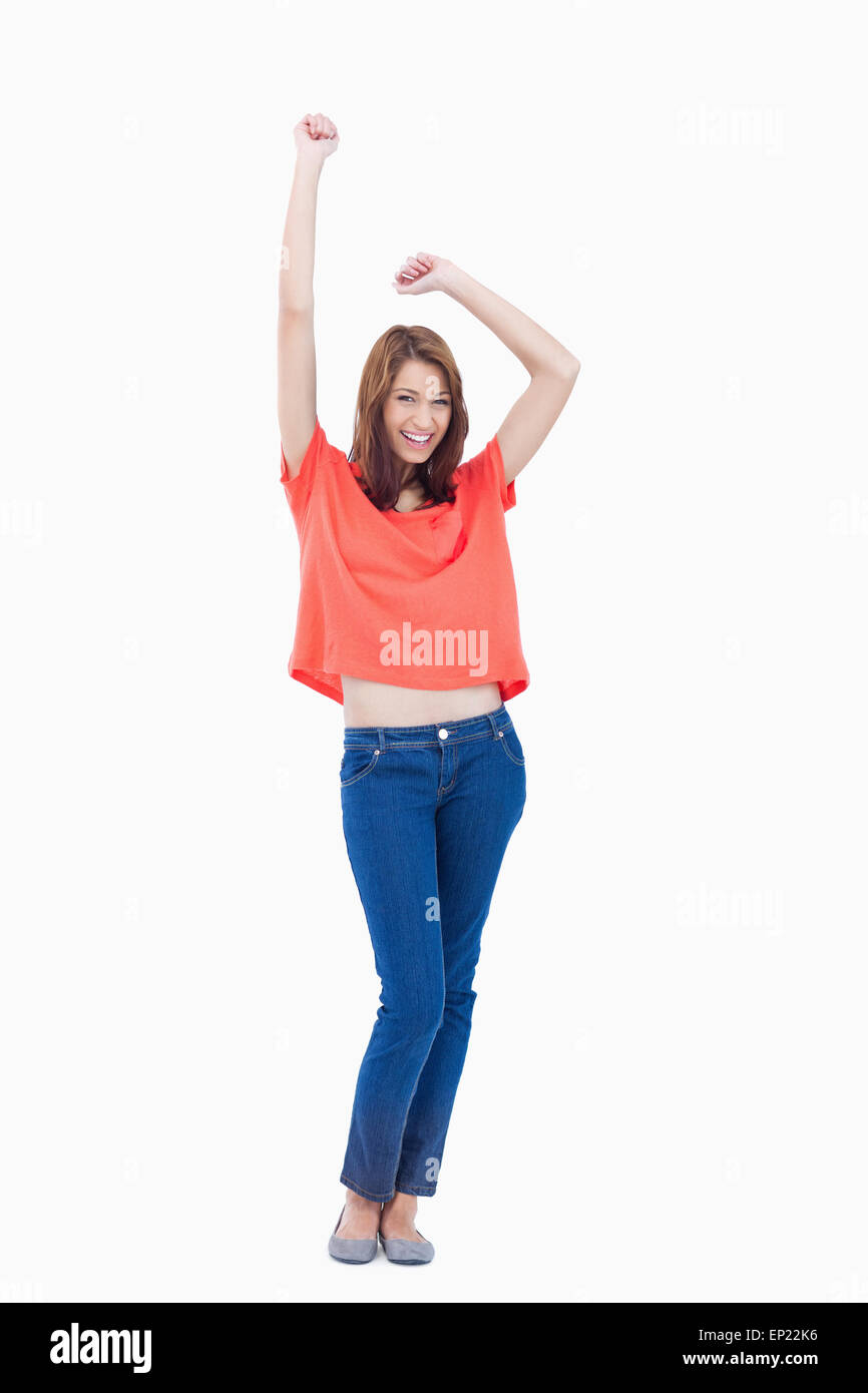 Casual teenager raising her arms above her head Stock Photo - Alamy