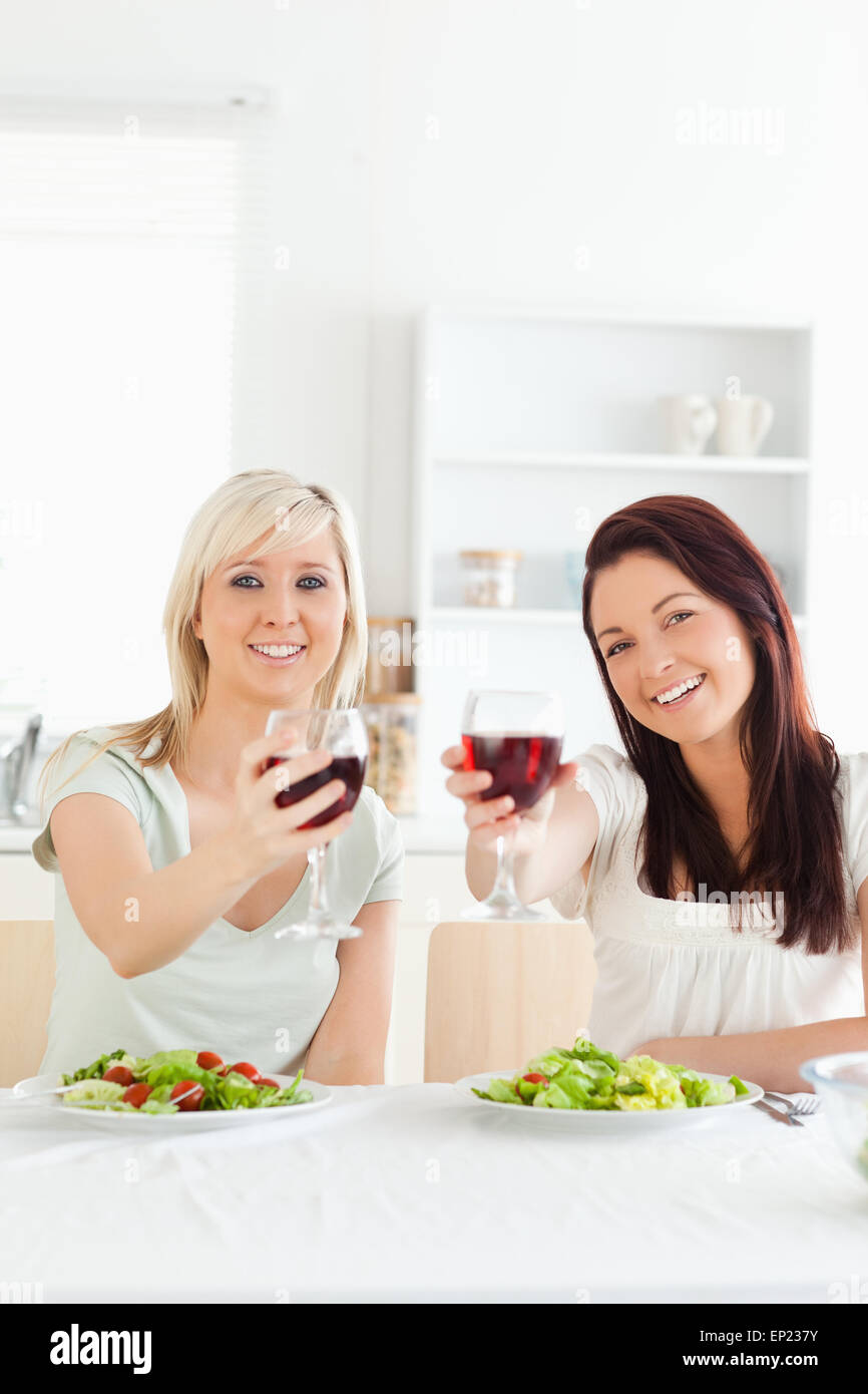 Young Women toasting with wine Stock Photo - Alamy
